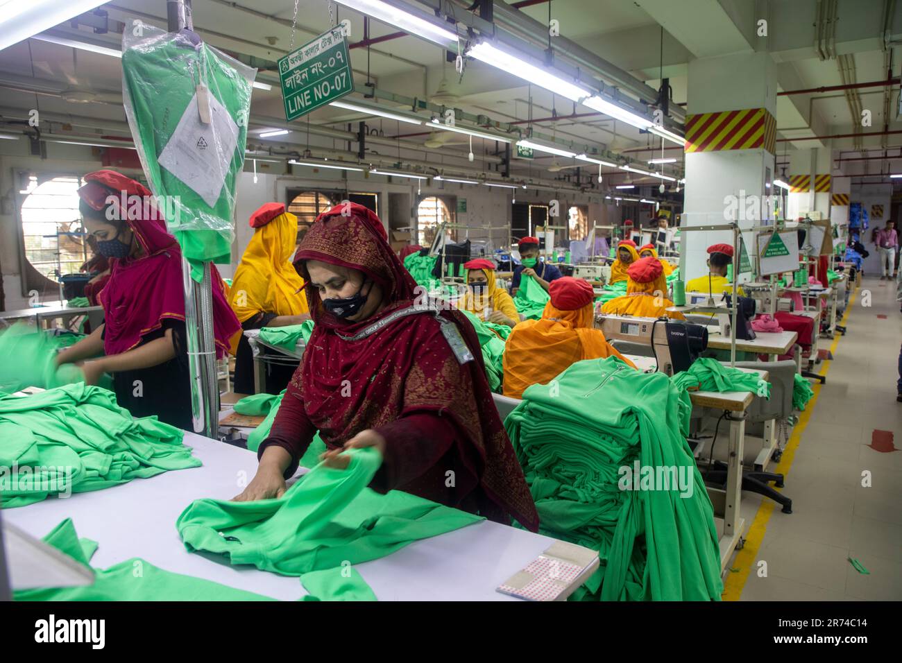 Ready-made garments (RMG) workers working in a factory at Fatullah in ...