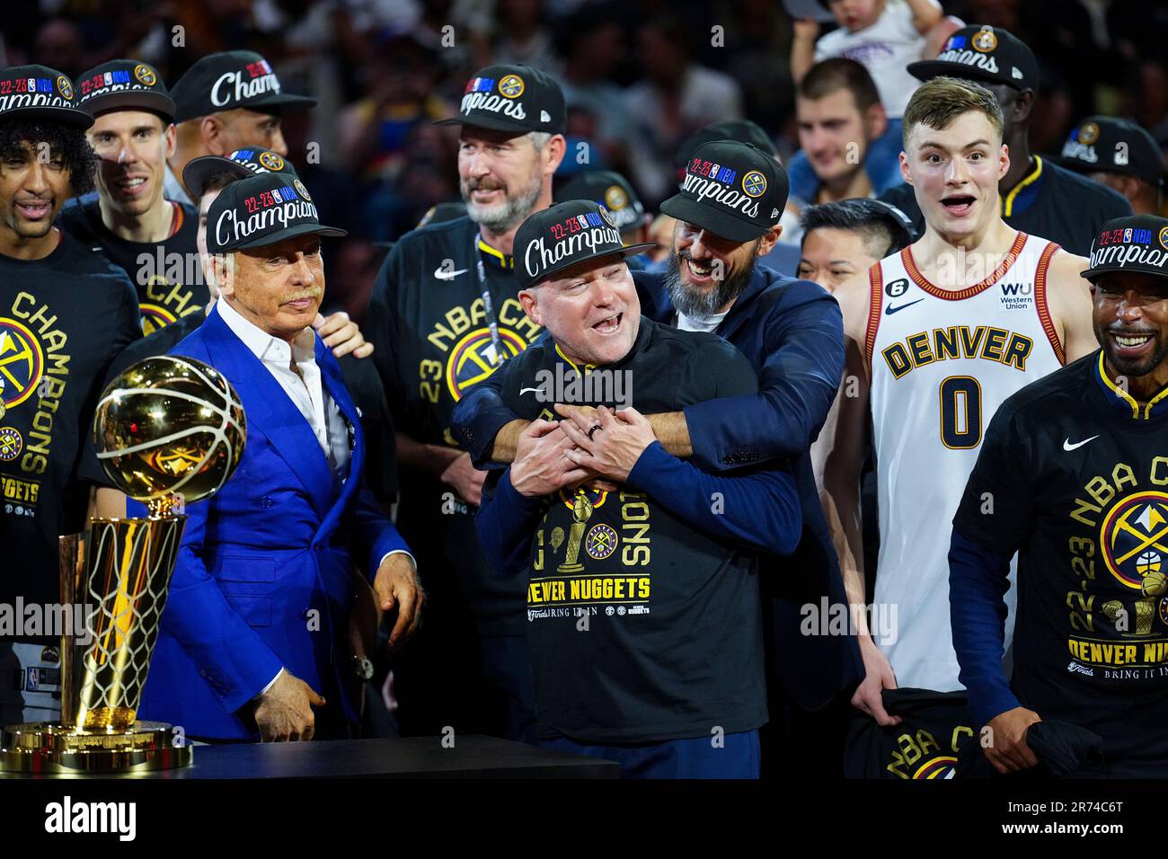 Denver Nuggets owner Josh Kroenke, center right, hugs head coach ...