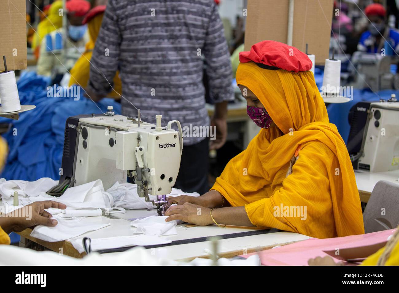 A ready-made garments (RMG) worker working in a factory at Fatullah in Narayanganj, Bangladesh ...
