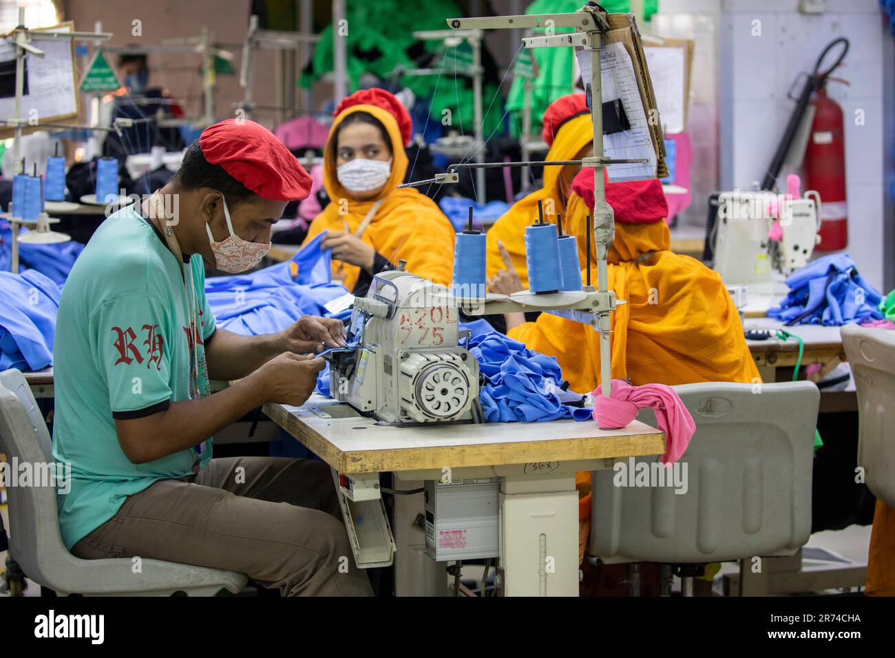 Ready-made garments (RMG) workers working in a factory at Fatullah in ...