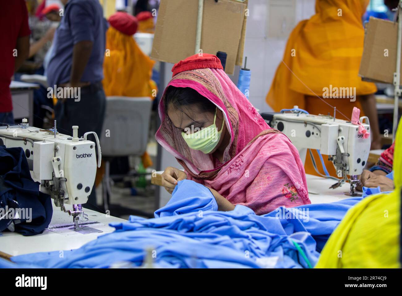 A ready-made garments (RMG) worker working in a factory at Fatullah in ...