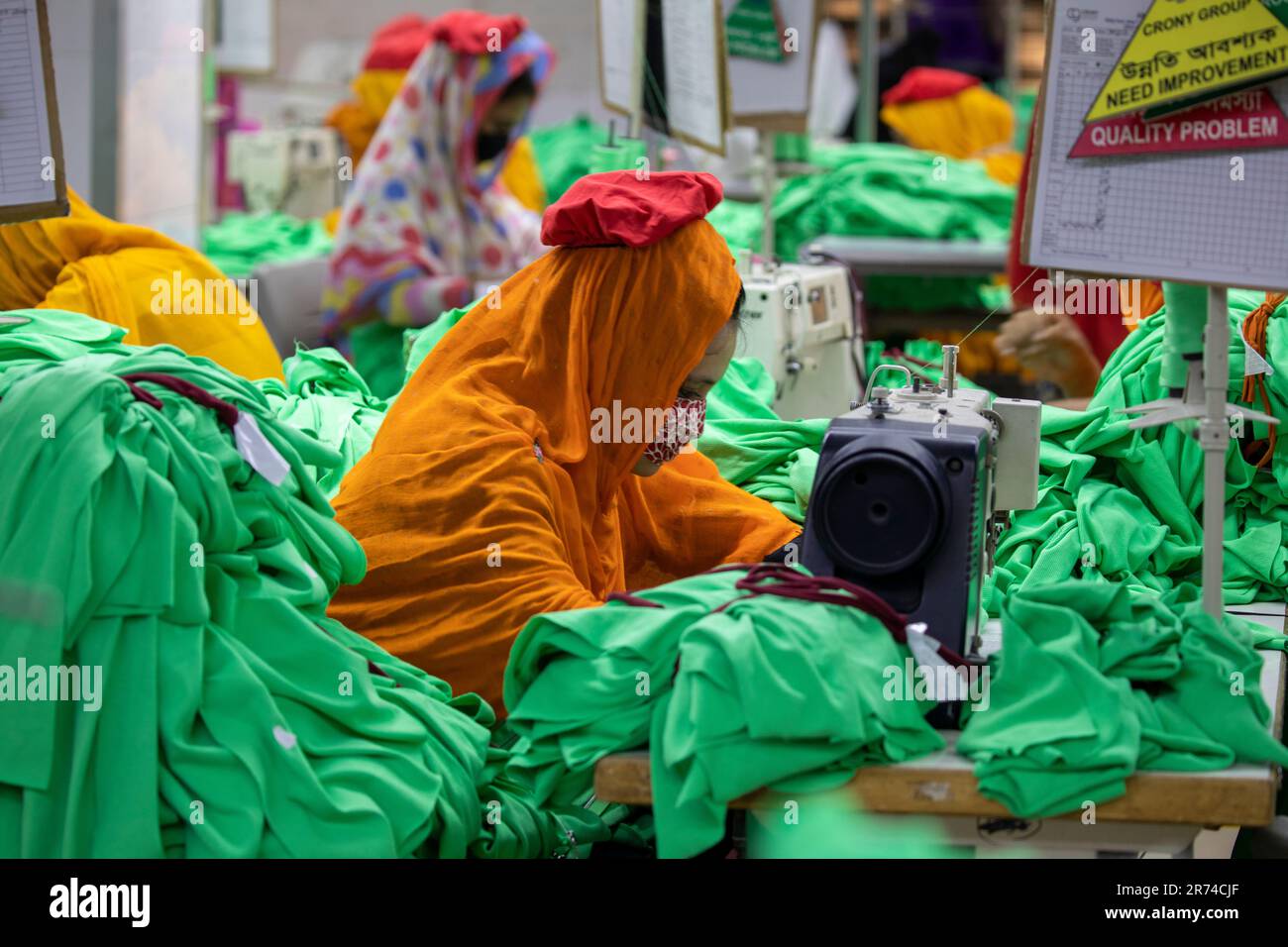 A ready-made garments (RMG) worker working in a factory at Fatullah in ...