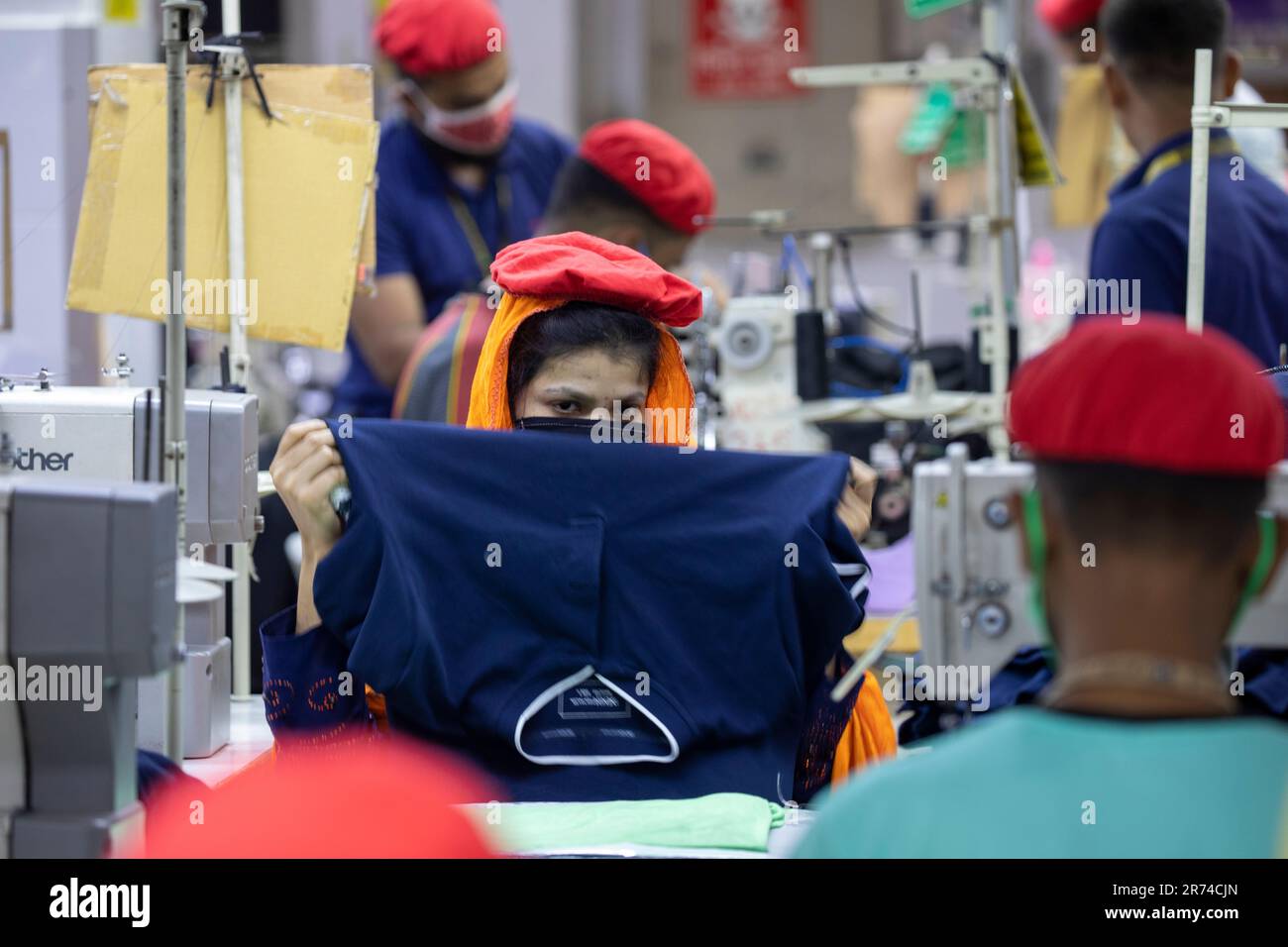 Ready-made garments (RMG) workers working in a factory at Fatullah in ...