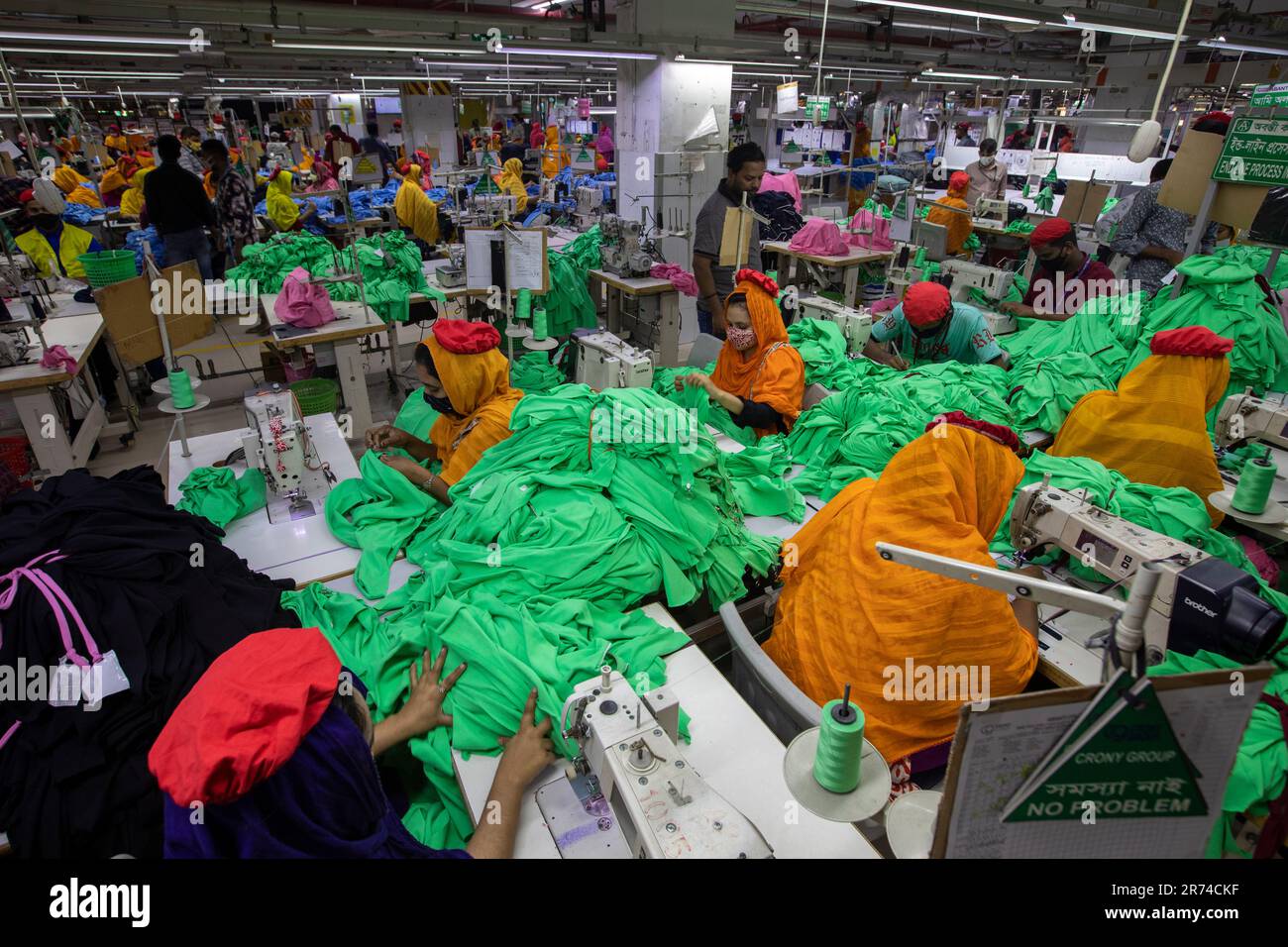 Ready-made garments (RMG) workers working in a factory at Fatullah in ...