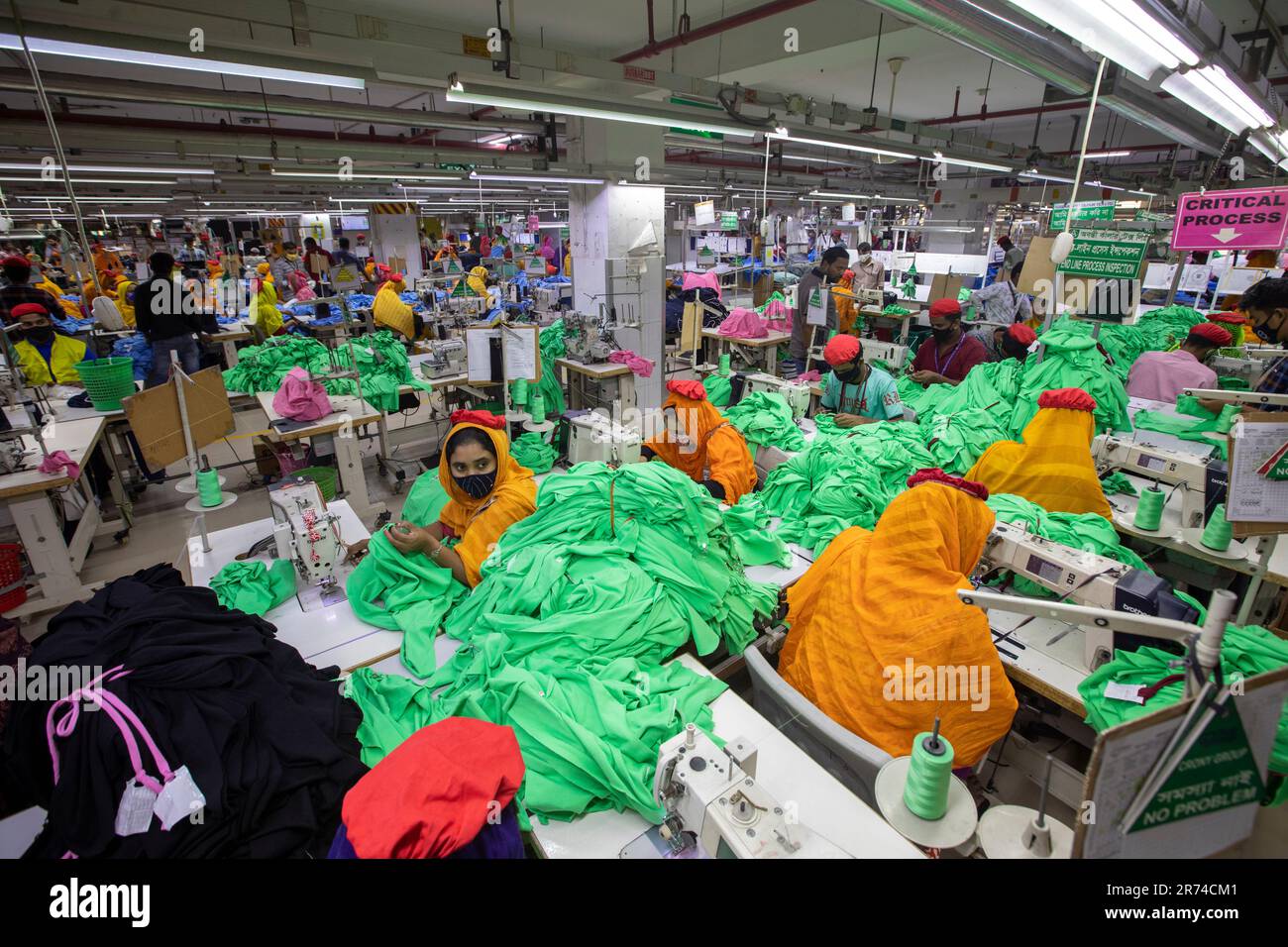 Ready-made garments (RMG) workers working in a factory at Fatullah in ...