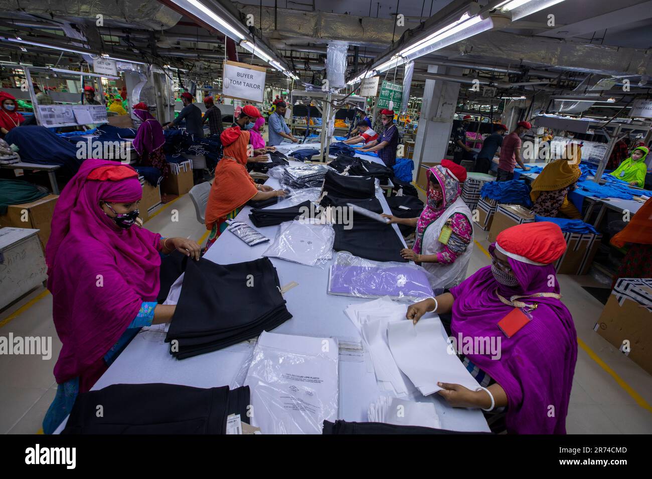 Ready-made garments (RMG) workers working in a factory at Fatullah in ...