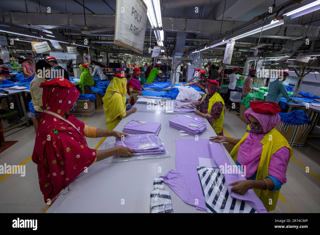Ready-made garments (RMG) workers working in a factory at Fatullah in ...