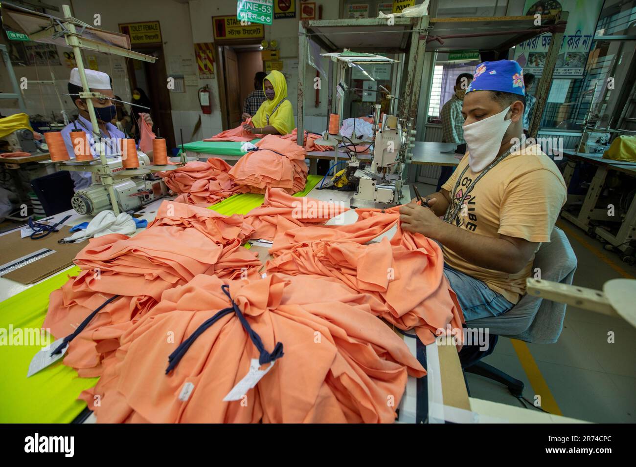Ready-made garments (RMG) workers working in a factory at Fatullah in ...