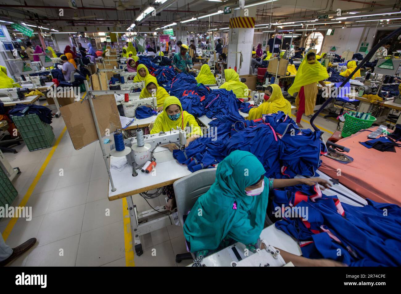Ready-made garments (RMG) workers working in a factory at Fatullah in ...