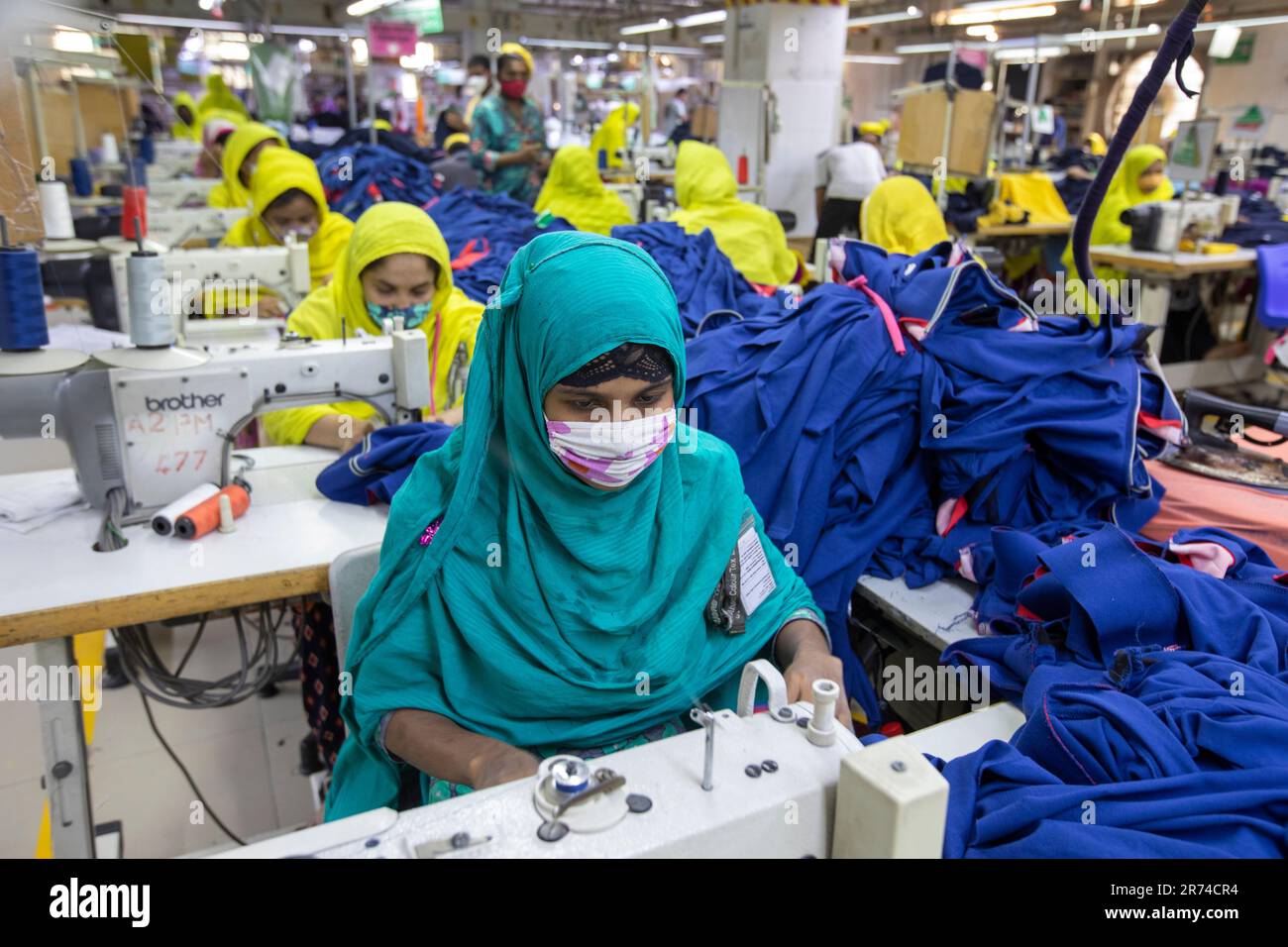 Ready-made garments (RMG) workers working in a factory at Fatullah in ...