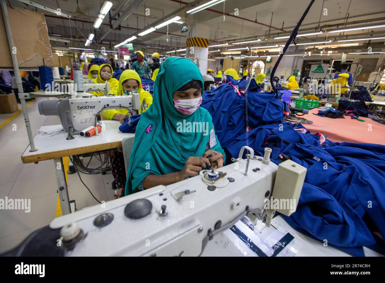 Ready-made garments (RMG) workers working in a factory at Fatullah in ...