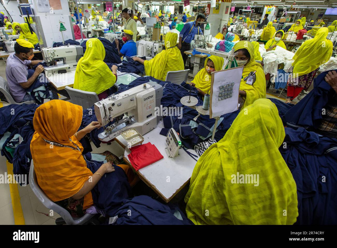 Ready-made garments (RMG) workers working in a factory at Fatullah in ...