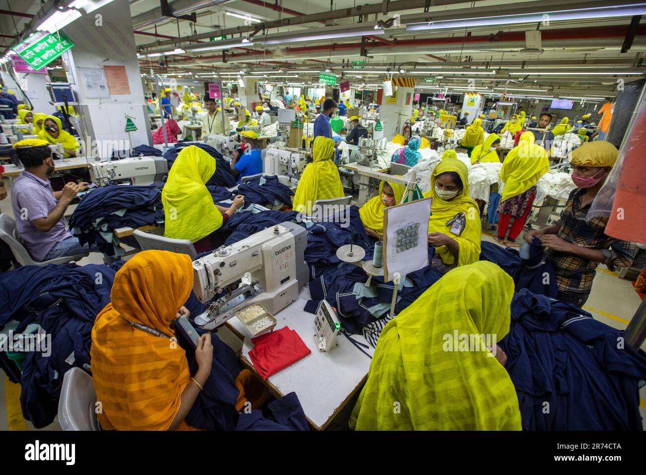Ready-made garments (RMG) workers working in a factory at Fatullah in ...