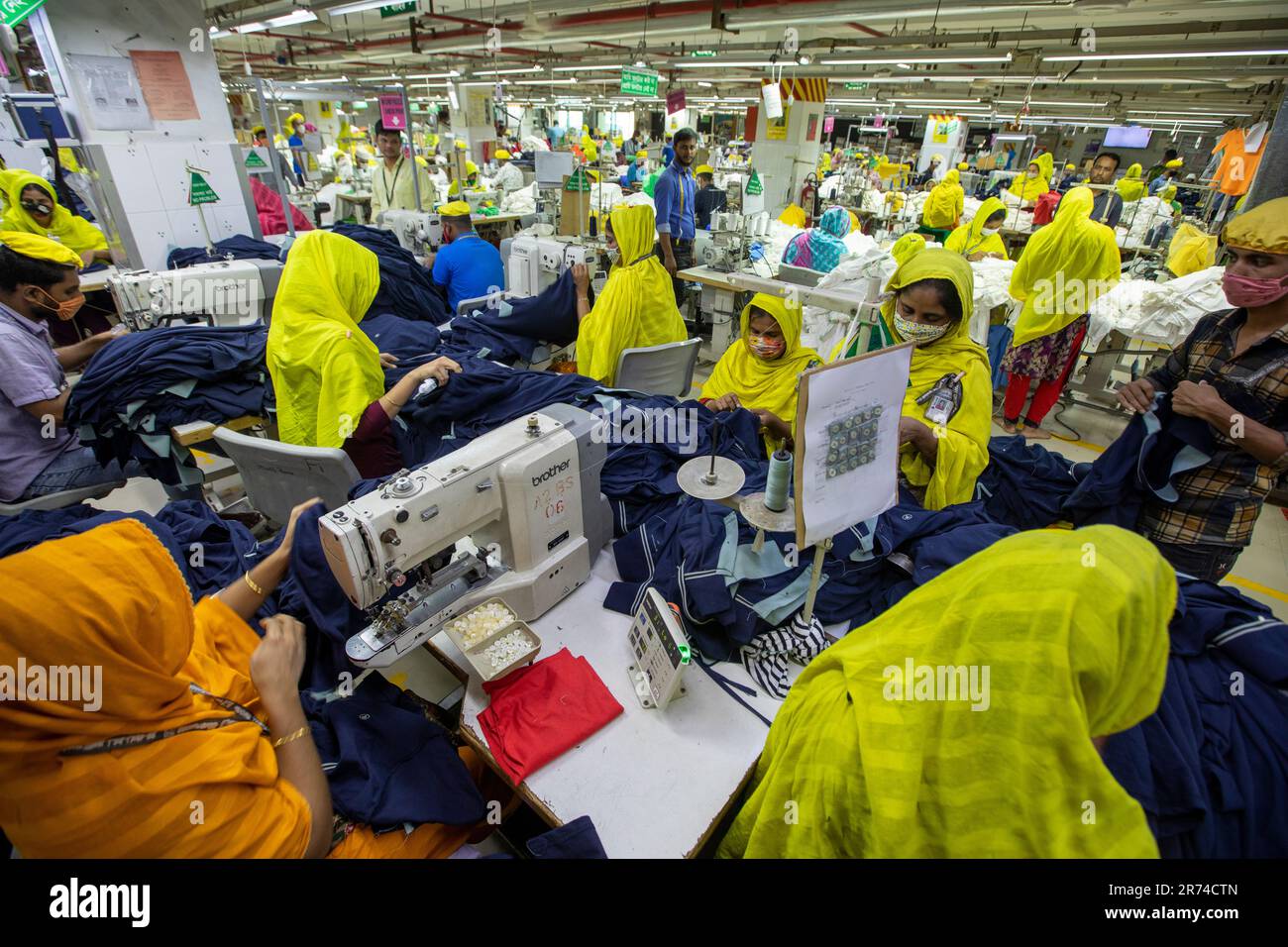 Ready-made garments (RMG) workers working in a factory at Fatullah in ...