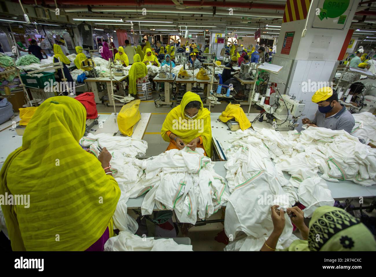 Ready-made garments (RMG) workers working in a factory at Fatullah in ...