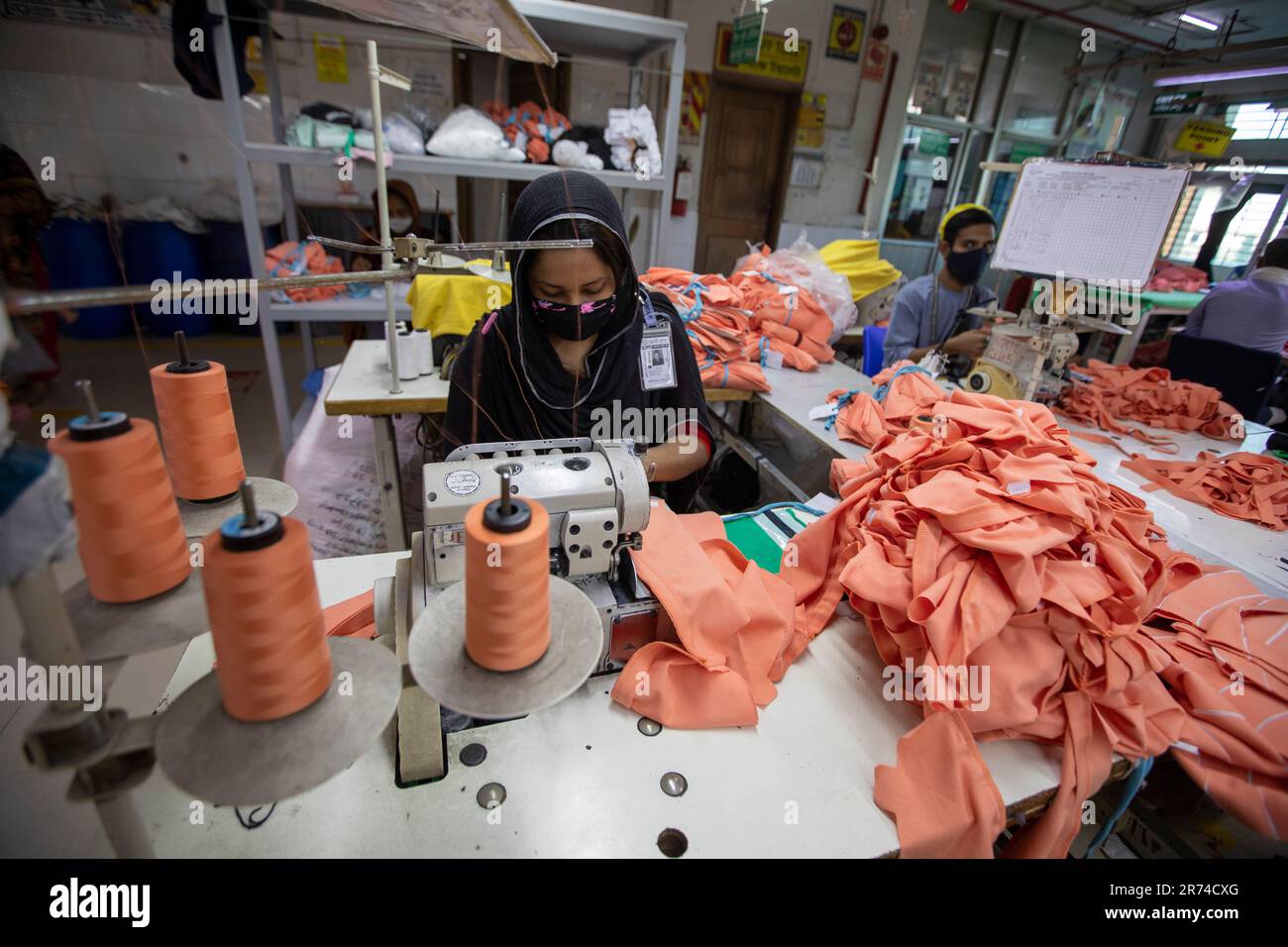 Ready-made garments (RMG) workers working in a factory at Fatullah in ...