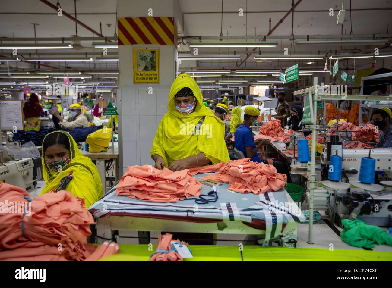 Ready-made garments (RMG) workers working in a factory at Fatullah in ...