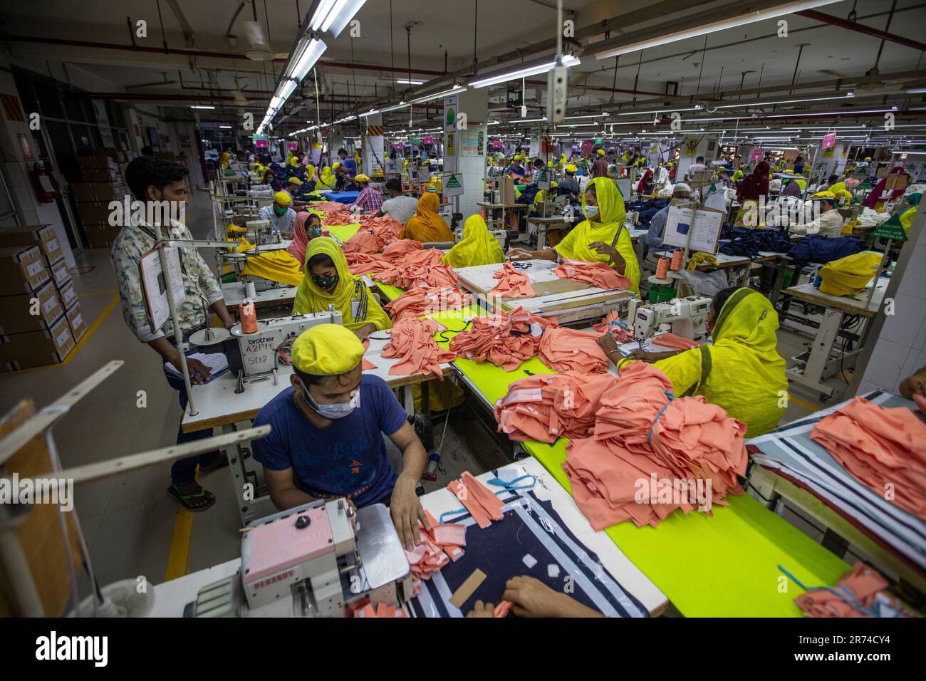 Ready-made garments (RMG) workers working in a factory at Fatullah in ...