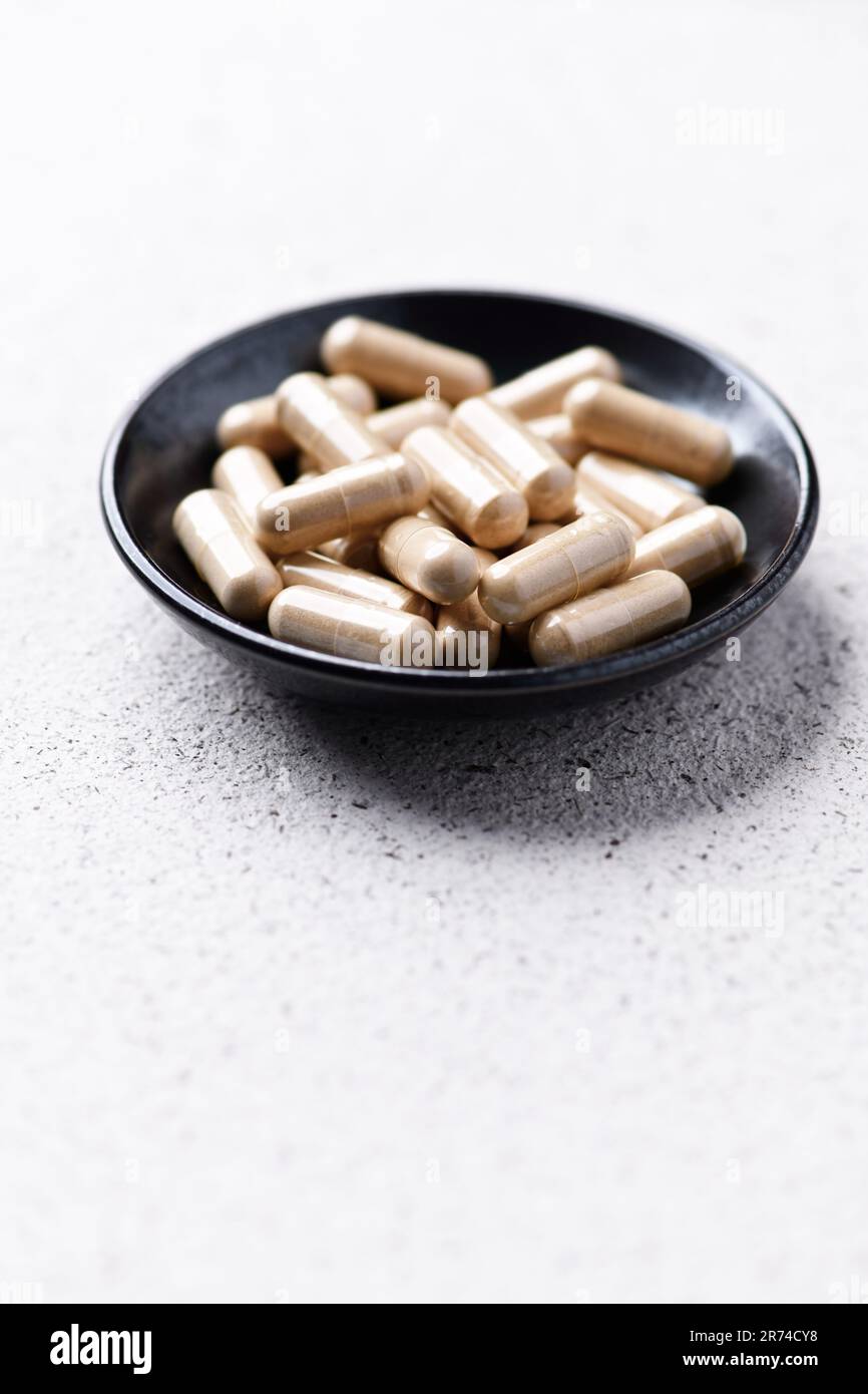 Ashwagandha (Withania somnifera) capsules. Bright paper background ...