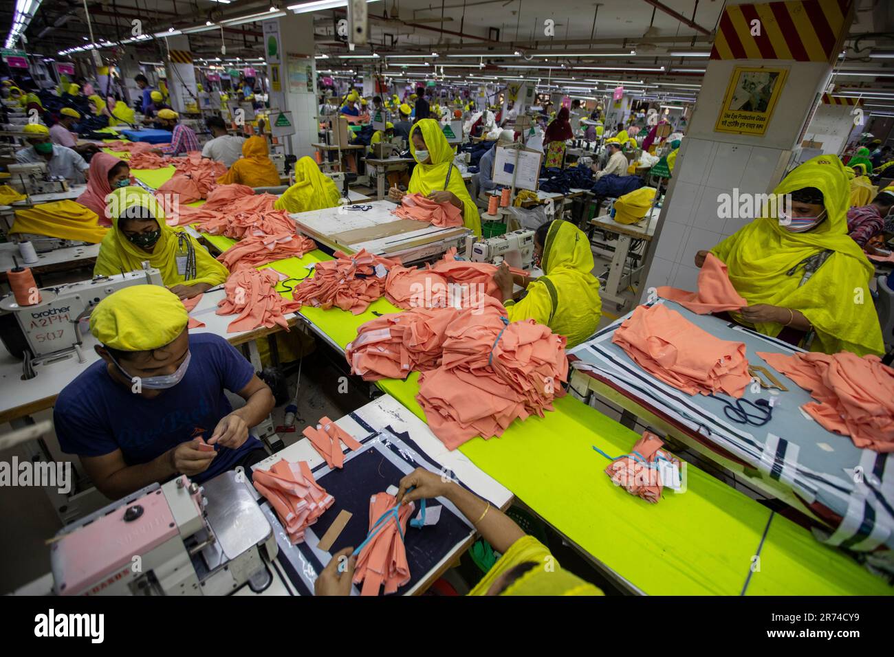 Ready-made garments (RMG) workers working in a factory at Fatullah in ...