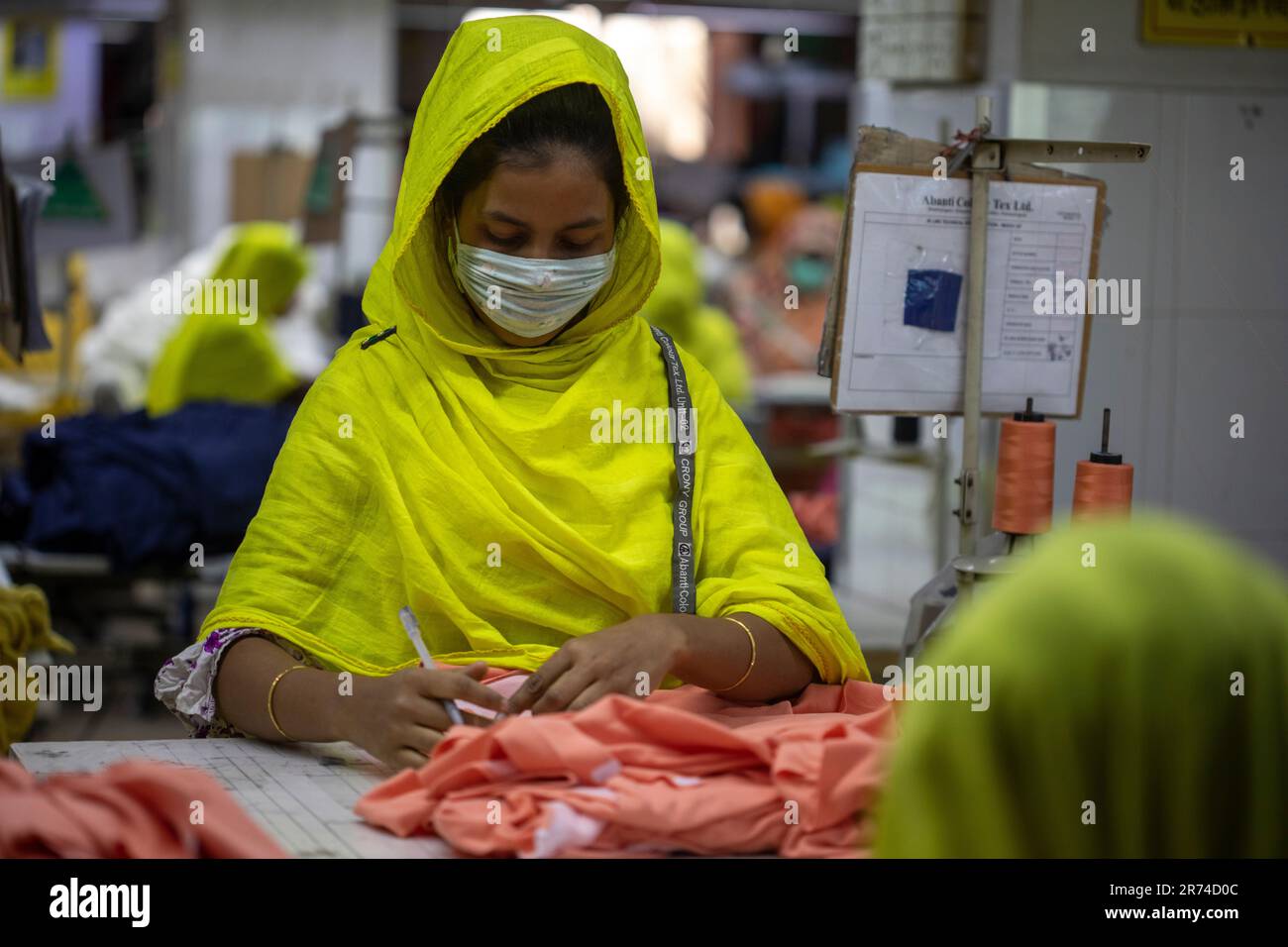A ready-made garments (RMG) worker working in a factory at Fatullah in ...
