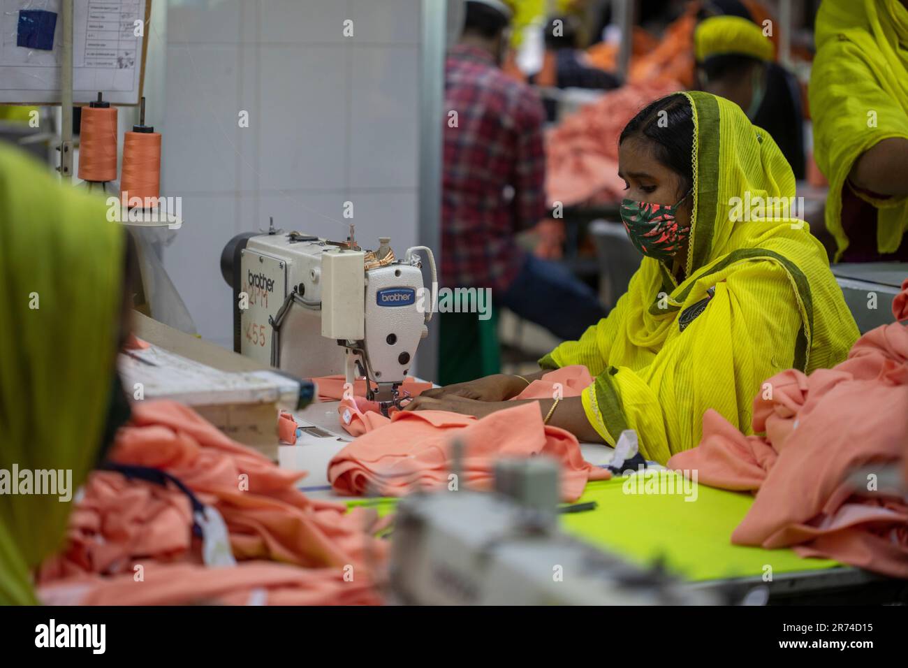 Ready-made garments (RMG) workers working in a factory at Fatullah in Narayanganj, Bangladesh ...