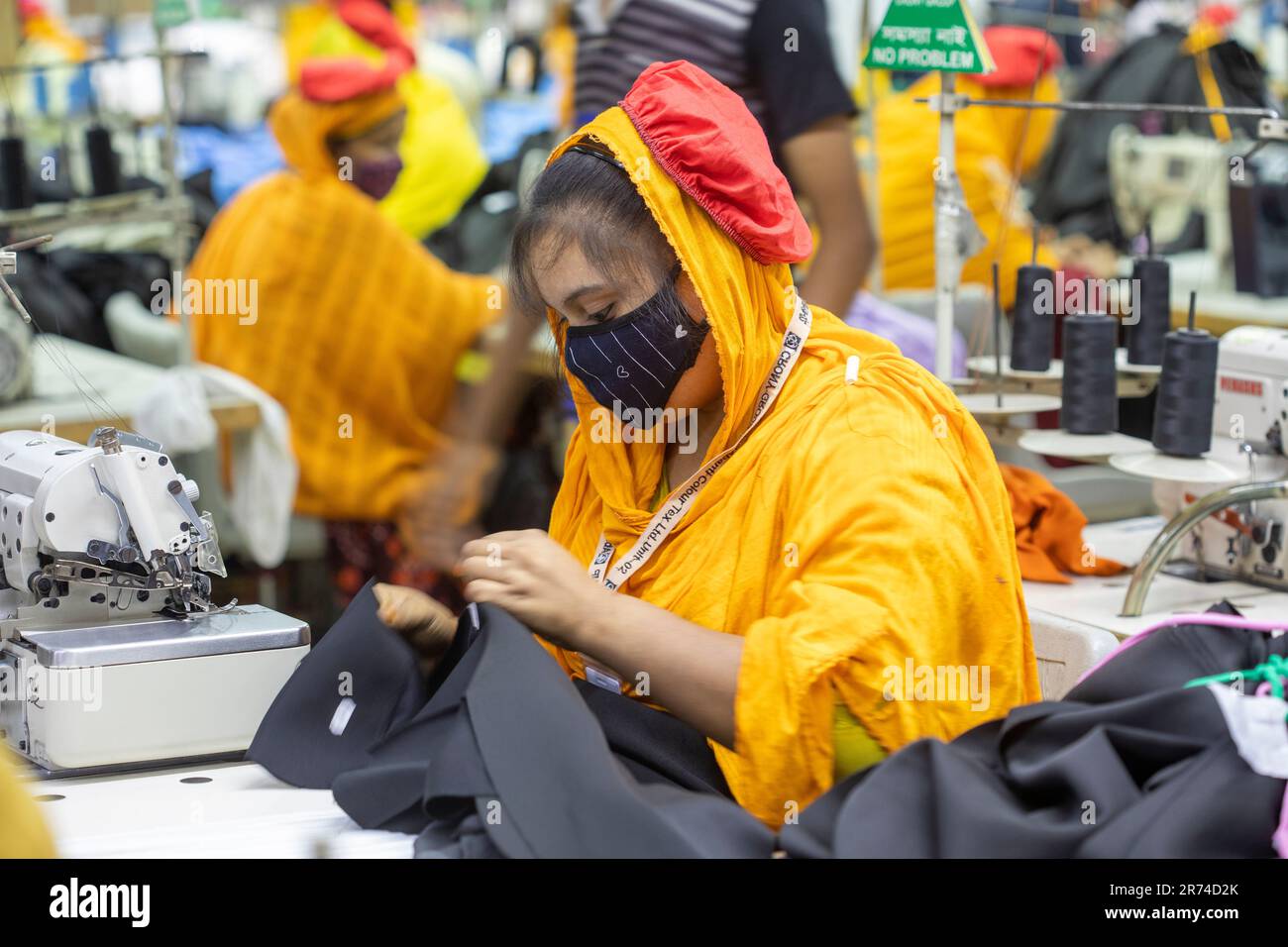 Ready-made garments (RMG) workers working in a factory at Fatullah in ...