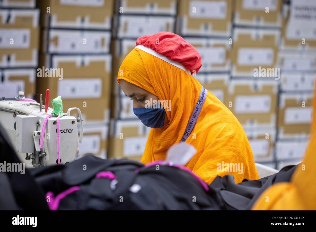A ready-made garments (RMG) worker working in a factory at Fatullah in ...