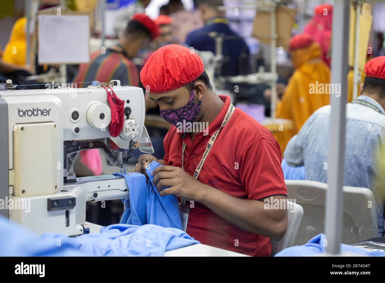 Ready-made garments (RMG) workers working in a factory at Fatullah in ...