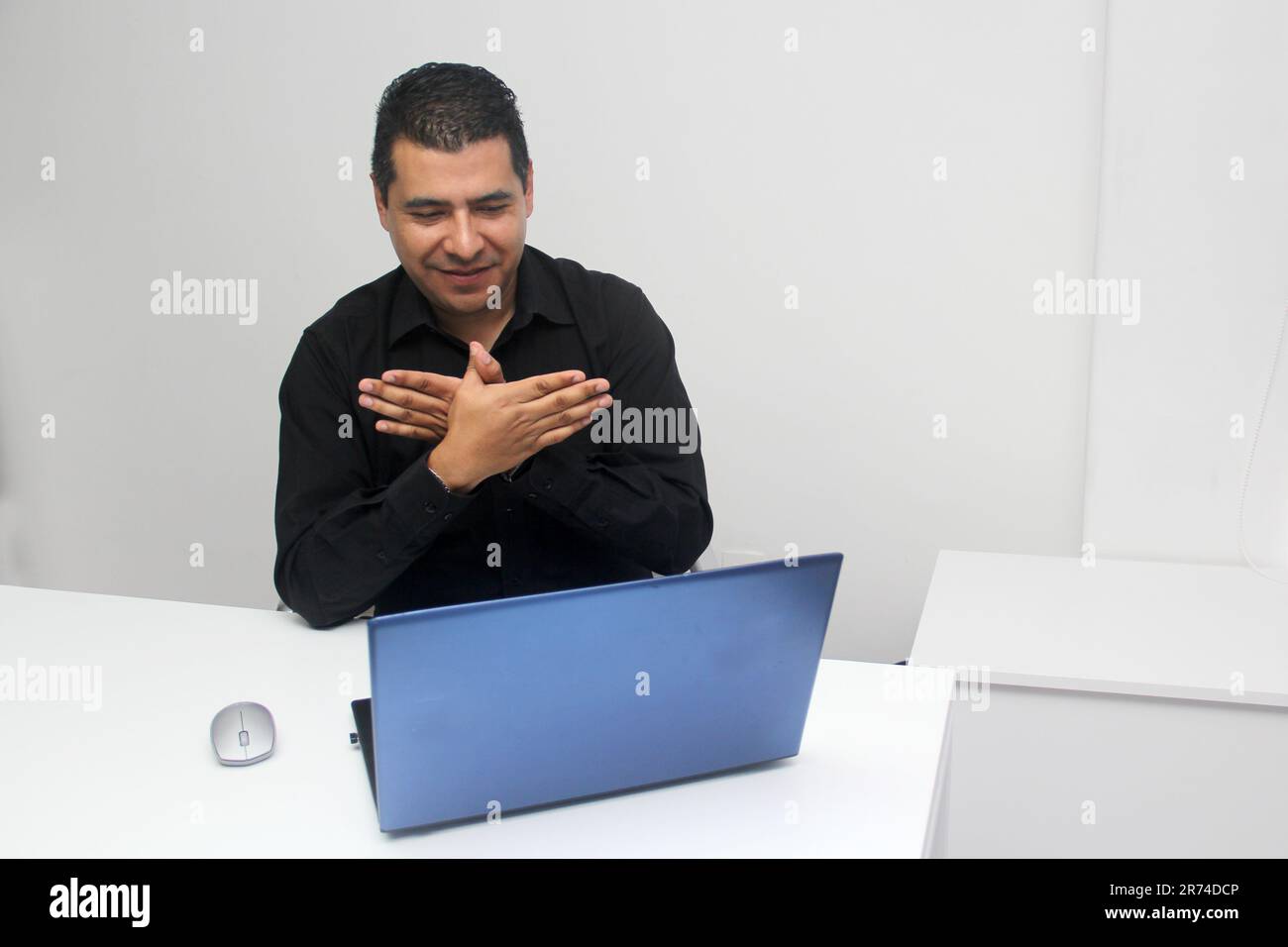Latino adult man speaks Mexican sign language with a deaf person ...