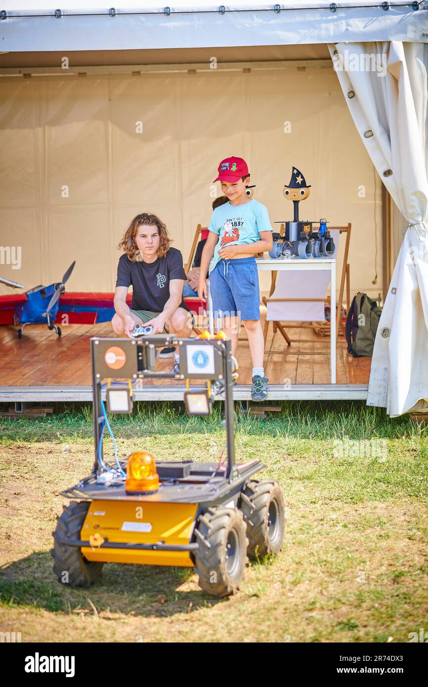 A cheerful instructor demonstrates robotic technology to an ...