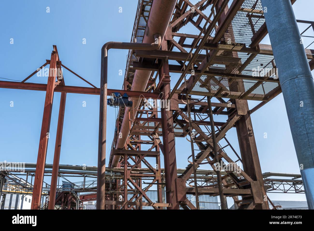 old rusty pipes, ladders and frames and metal inside an industrial ...