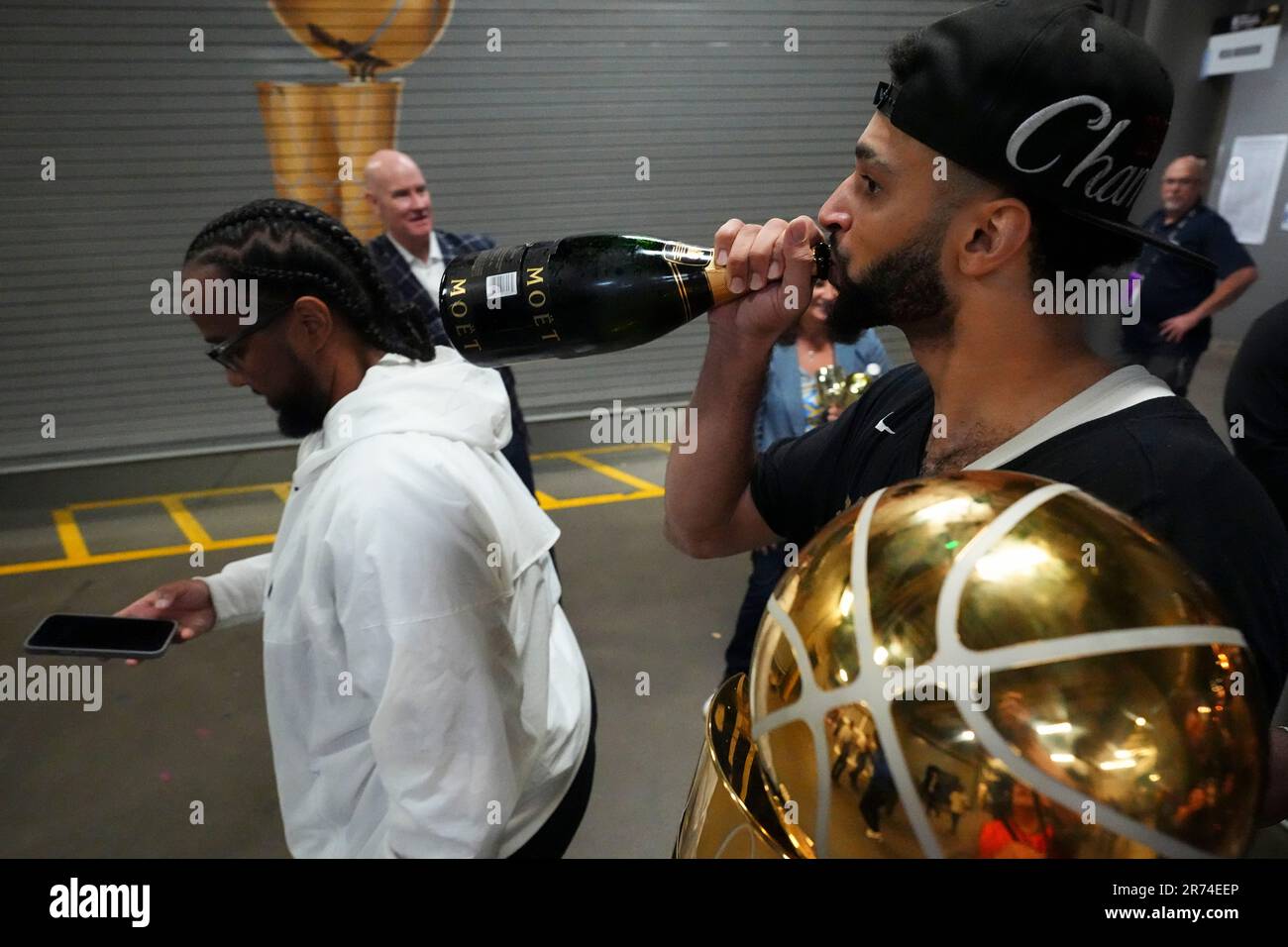 Denver Nuggets' Jamal Murray, right, holds the Larry O'Brien NBA ...