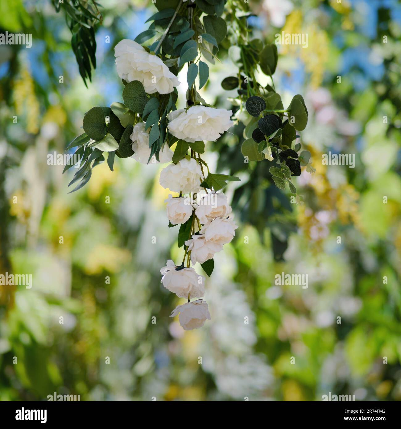 A paradisiacal archway adorned with alluring flowers, drooping blossoms ...