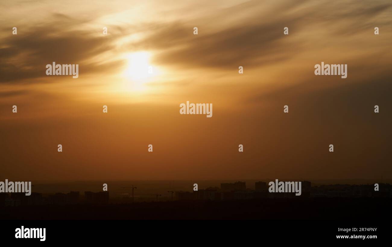 Sunset sky with red light of the setting sun. Evening clouds in the ...