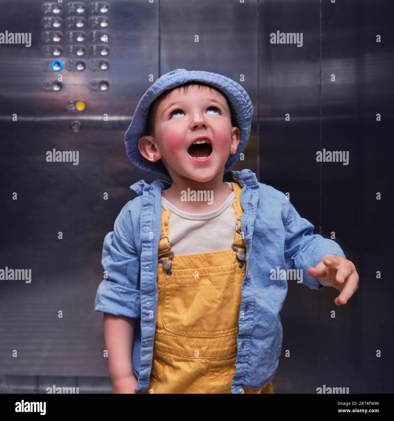 Happy baby rides in the elevator of an apartment building with buttons ...