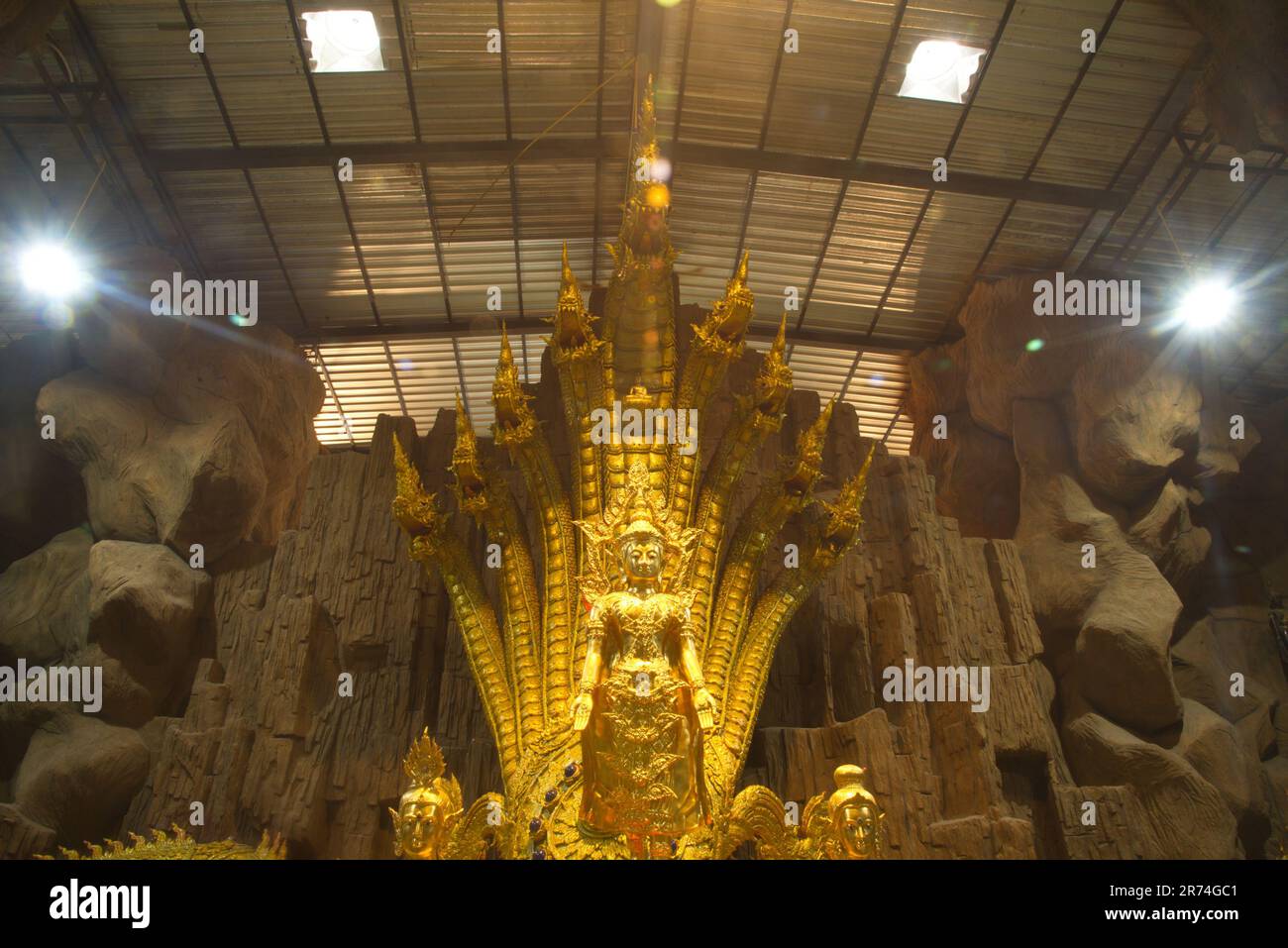 The standing Buddha image is in the posture of a serpent with a serpent ...