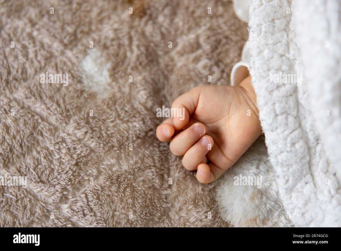 A right hand of sleeping asian baby on the carpet Stock Photo - Alamy