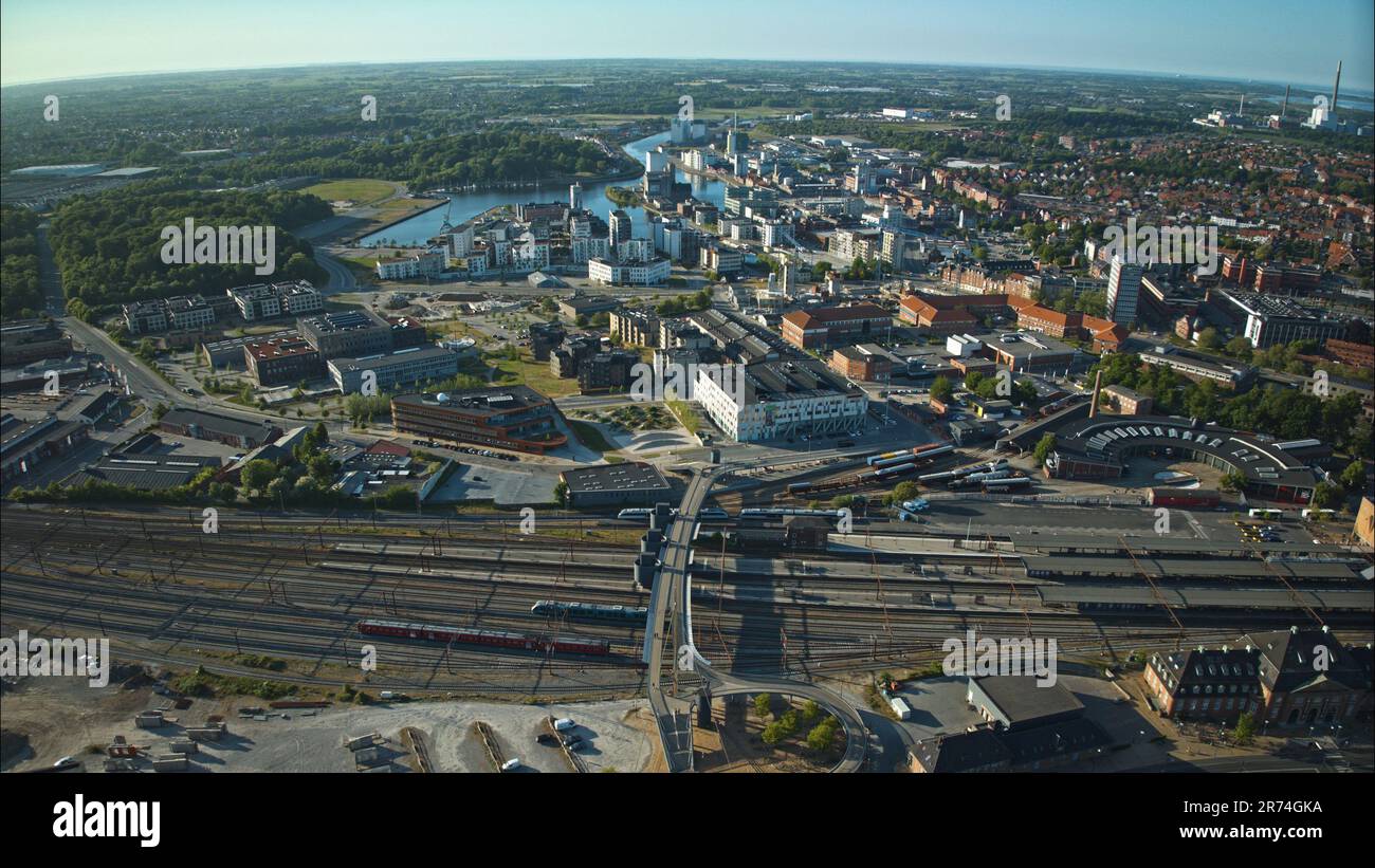 An aerial view of a vibrant cityscape situated by a serene body of ...