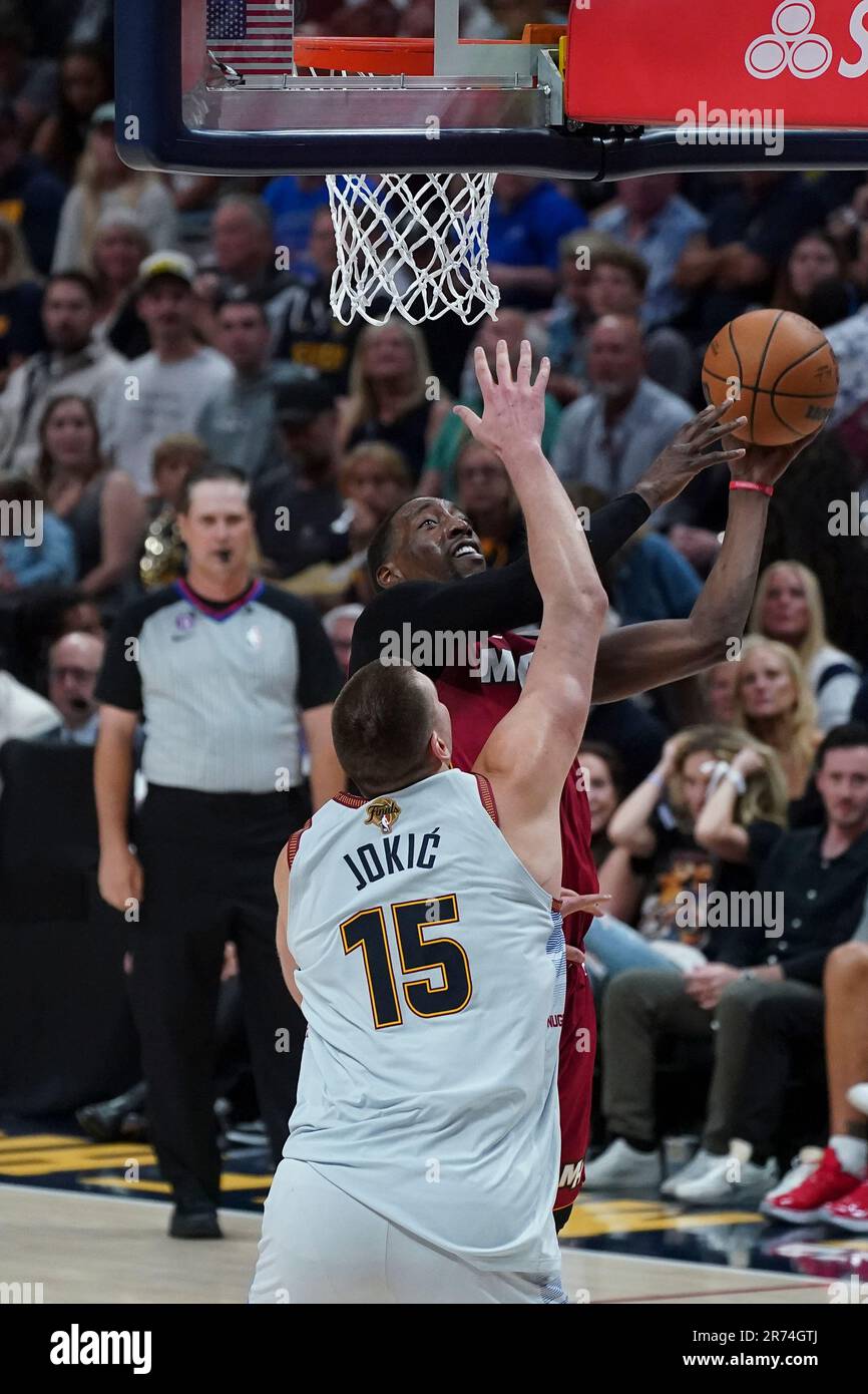 Miami Heat center Bam Adebayo, rear, shoots while defended by Denver ...