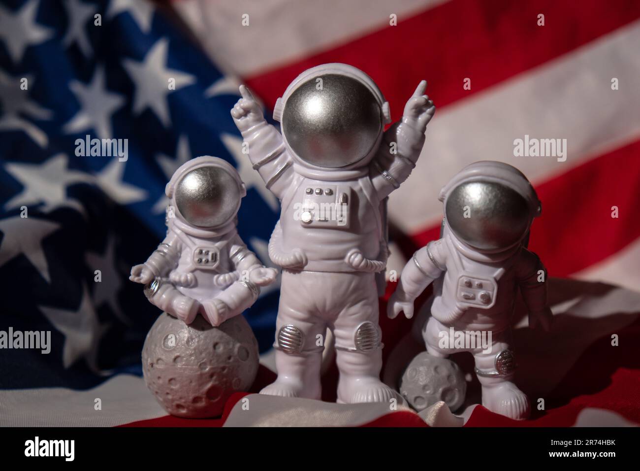 Three Plastic toys figure astronaut on American flag background Copy ...