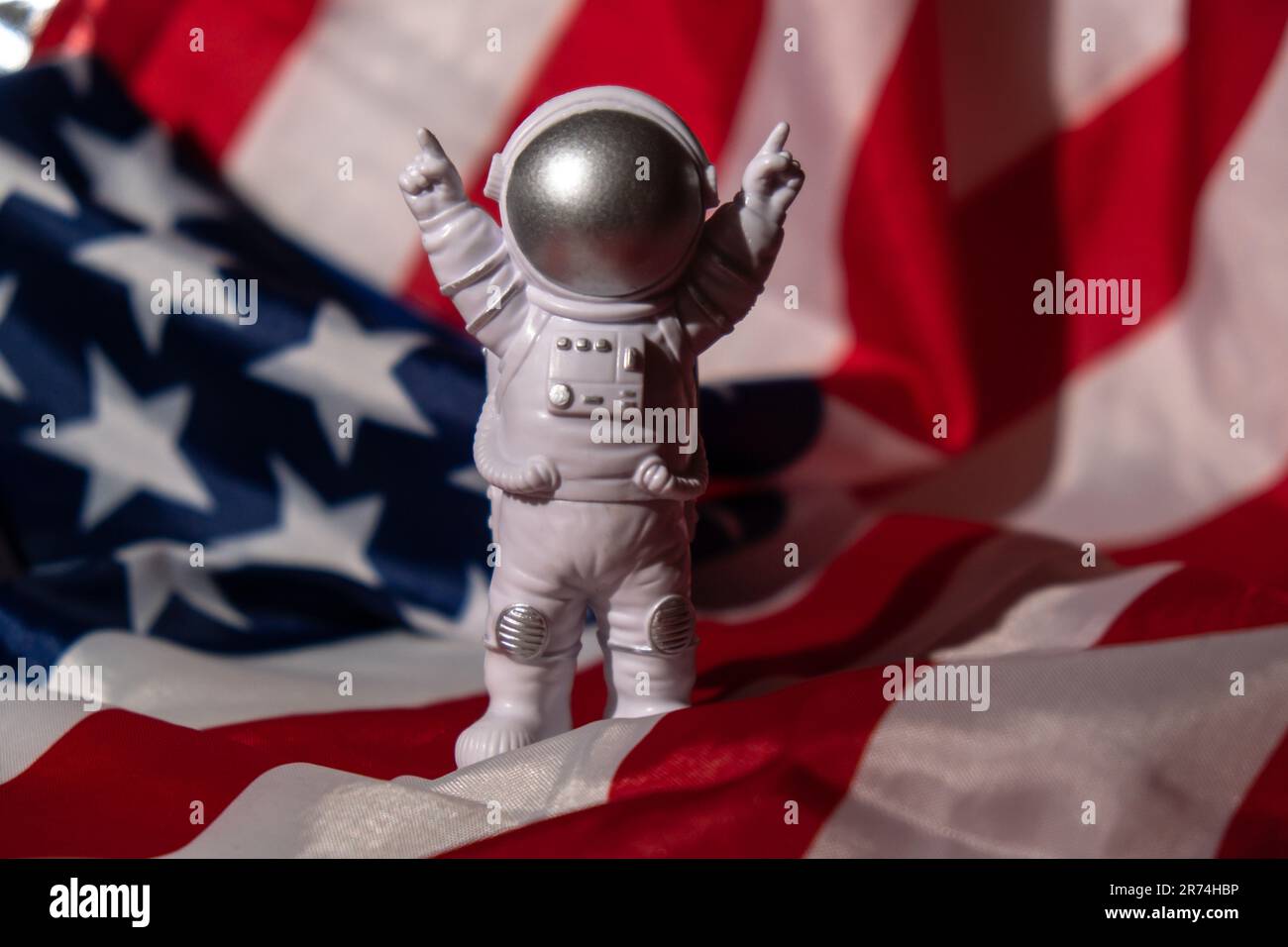 Plastic toy figure astronaut on American flag background Copy space ...
