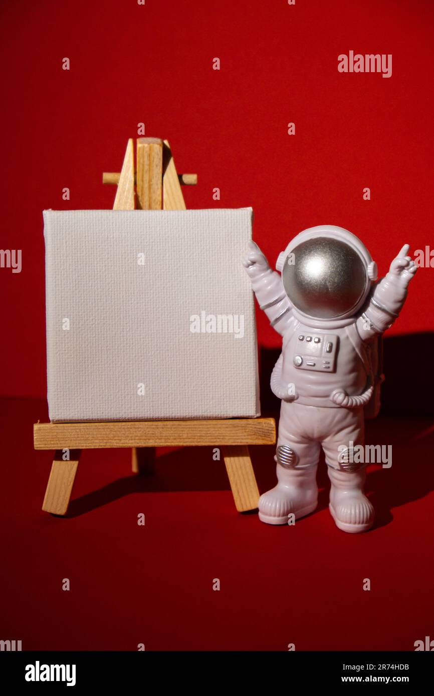 Plastic toy astronaut with paper note template mock up for your text on ...