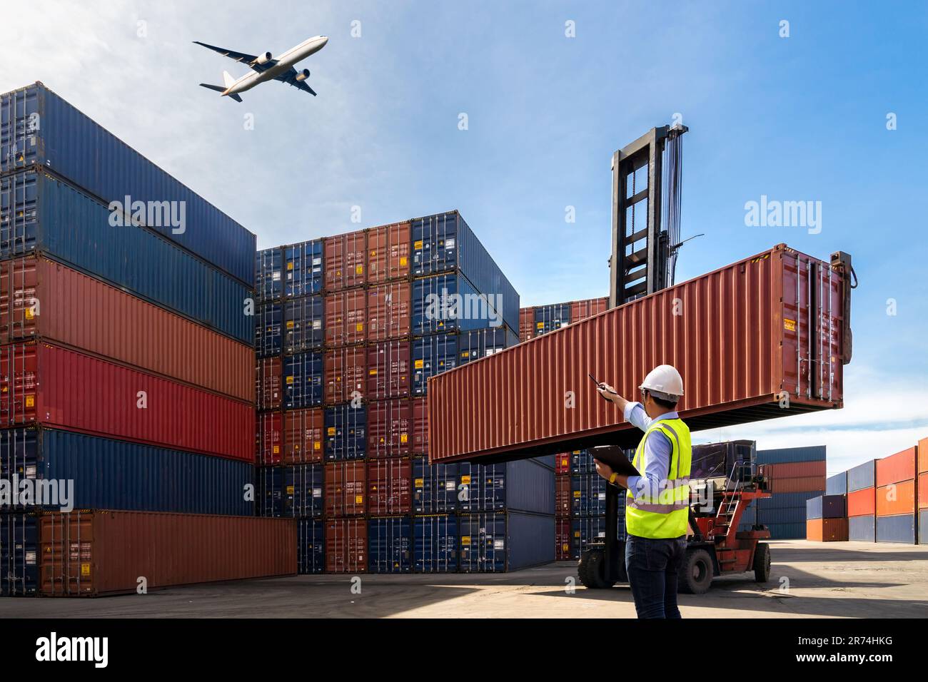 Foreman control loading Containers box from Cargo freight ship for ...