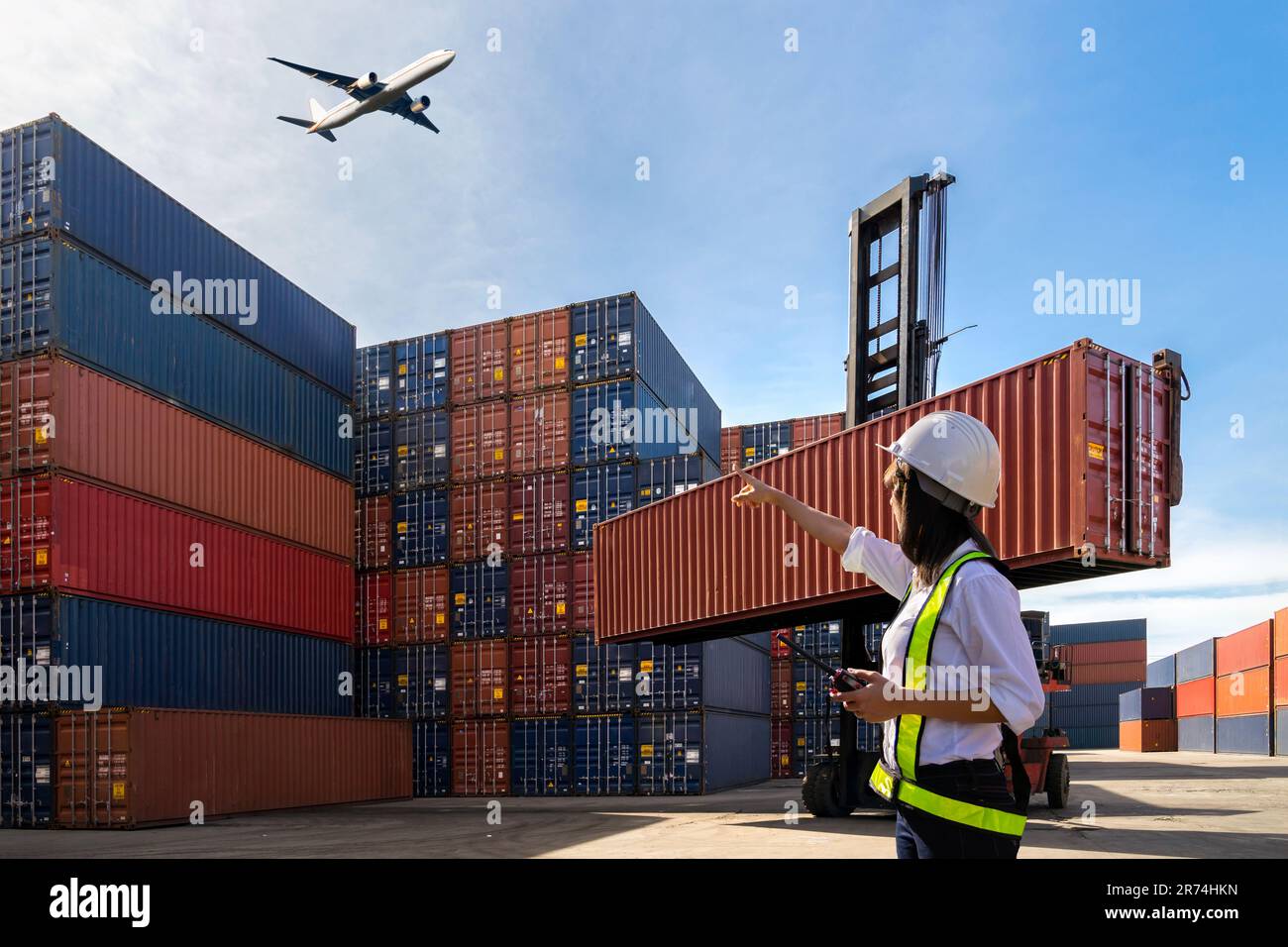 Foreman Woman control loading Containers box from Cargo freight ship ...