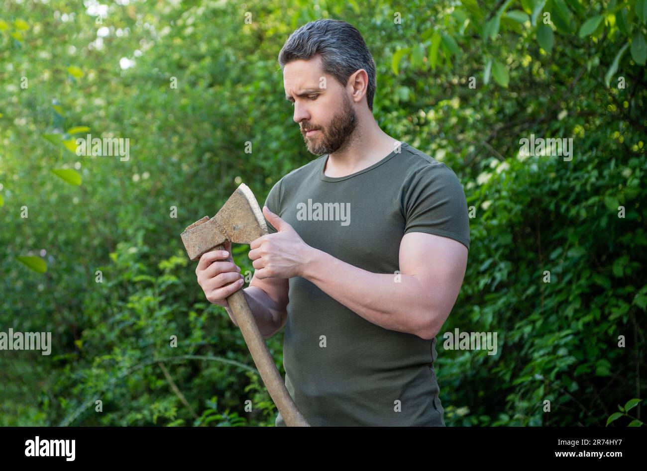man with ax wearing shirt, masculinity. man with ax outdoor. photo of ...