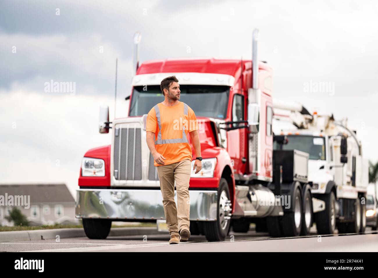 Highway engineer walking on highway. Man wearing orange safety vest for ...
