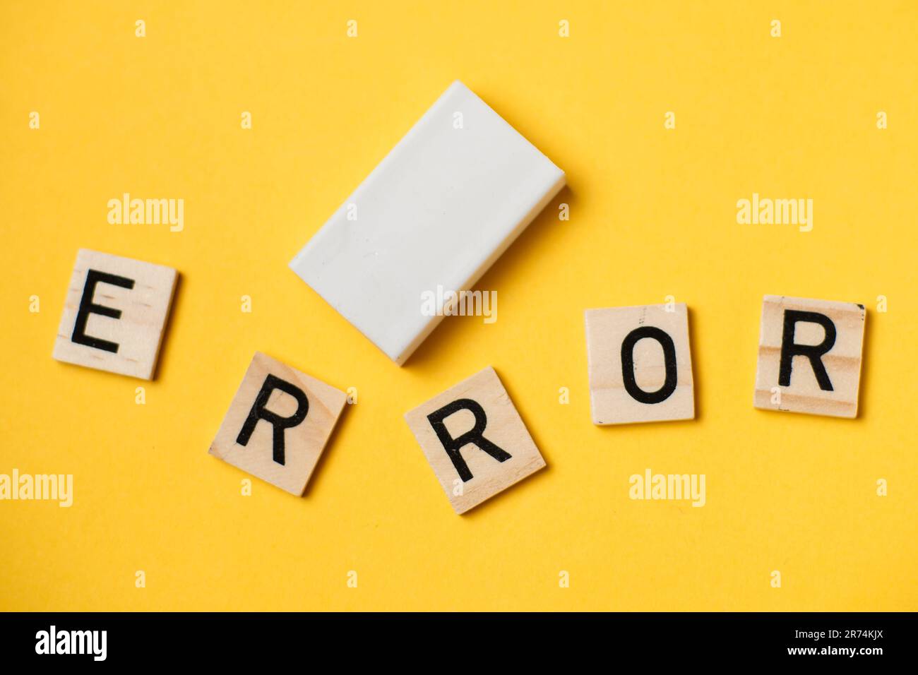 A word made of letters - error and eraser on a yellow background Stock ...
