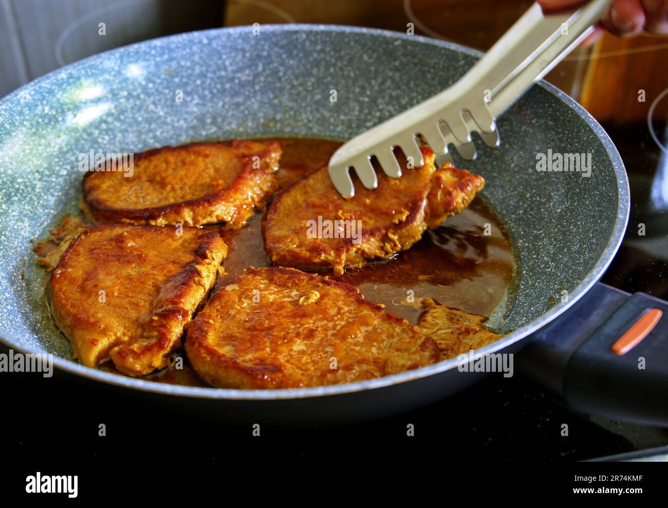 Fried pork steak in frying pan Stock Photo - Alamy