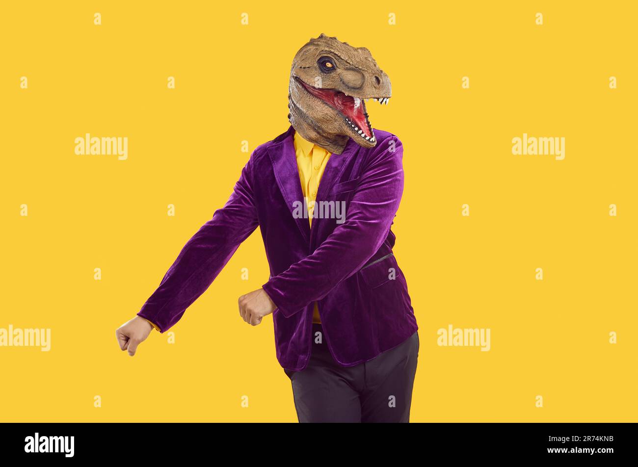 Funny cool man with laughing dinosaur head dancing Stock Photo - Alamy